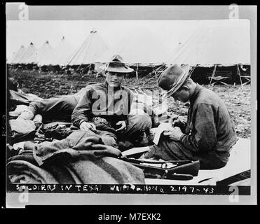 A black-and-white photograph of soldiers writing letters home during ...