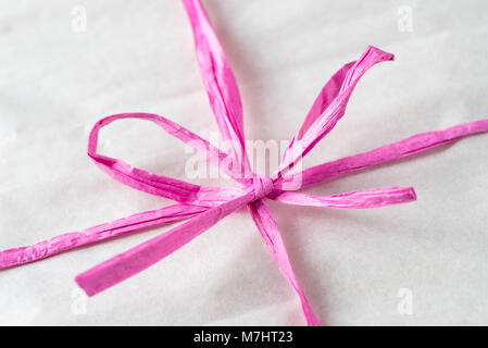 Small gift box wrapped pink and blue paper isolated on blue and pink ...