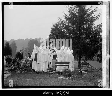A historical image depicting a Ku Klux Klan rally in 1965, illustrating a period of social and ...