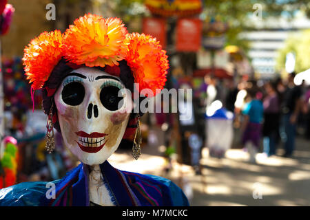 Skull painted and decorated with orange paper mache flowers and ...