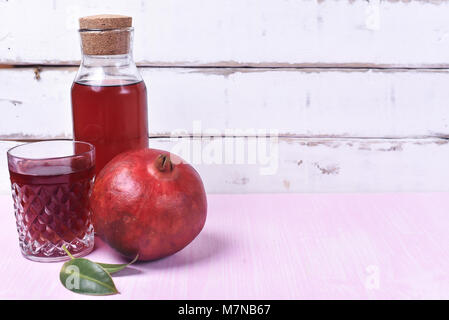 Grant and pomegranate juice on the table Stock Photo - Alamy