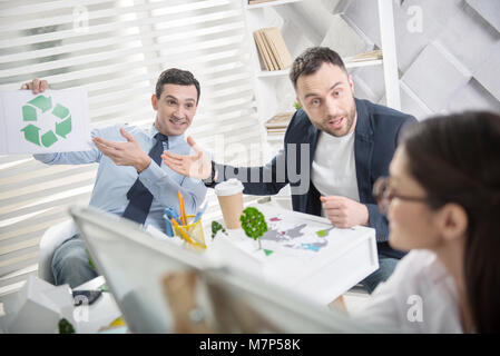Happy ecologists working on the project Stock Photo - Alamy
