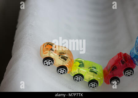 transparent coloured toy cars stuck in ice and snow Stock Photo - Alamy