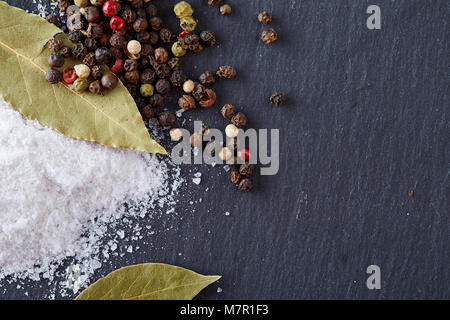 Composition of bay laurel leaf with peppercorn and salt isolated on ...