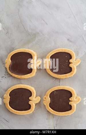 Sweet apple shaped cookies arranged in rows on light textured ...