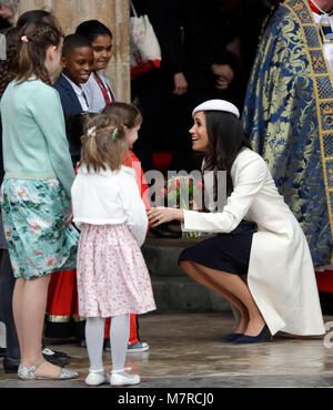 Meghan Markle receives flowers as she leaves after attending the ...