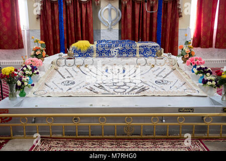 A Sikh woman at the altar at the Sikh Cultural Society temple in ...