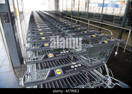 Parked shopping carts equipped with coin-operated locking mechanisms in ...