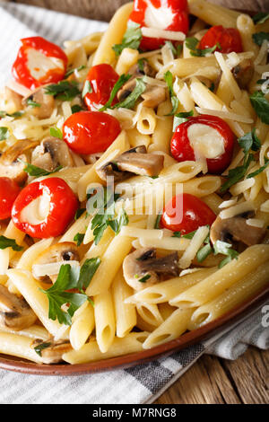 Tasty green pasta with pepper, and tomatoes on wooden table background ...