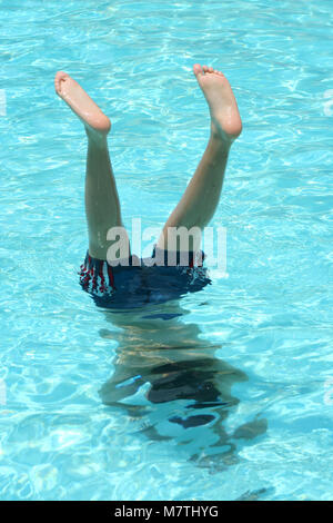 Boy doing a handstand in a swimming pool Stock Photo - Alamy