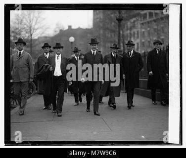 President Calvin Coolidge and other officials riding in a car during ...