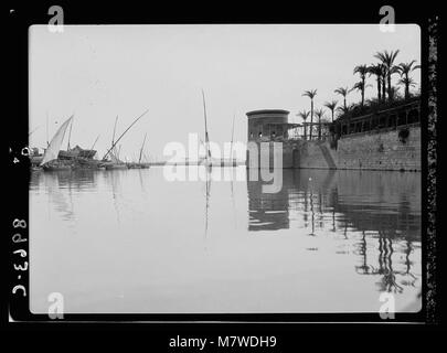 This photograph depicts the Nile River with the iconic pyramids of Giza ...