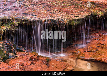 Water dripping over a ledge Stock Photo - Alamy