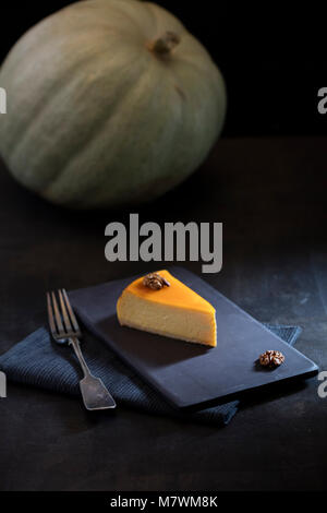 Slice of homemade pumpkin pie over a rustic wooden background. Extreme ...