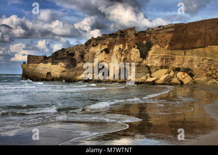 A panoramic view of beautiful caves on the shore of a beach in Paleo ...