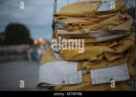 Tarpaulin market stall covers stored in a roll cage folded up and ready ...