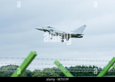 RAF Eurofighter Typhoon landing on runway 25 at RAF Coningsby out of a clear blue sky. Aircraft ...