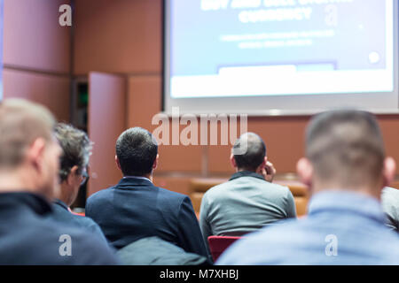 Listening to a presentation in a conference hall while standing Stock ...