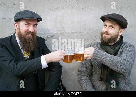 Two men with beards drink beer at The Great British Beer Festival, Earl ...
