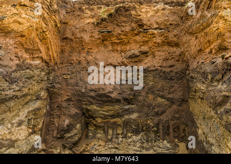 Multiple layers of earth showing deposits of ash from eruptions and ...