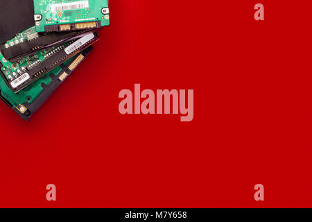 Hard drives in the corner of the frame on the red table with copy space ...