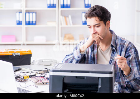 Hardware repairman repairing broken printer fax machine Stock Photo - Alamy