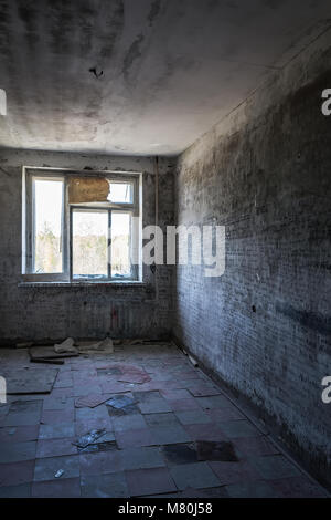 Interior of abandoned mental hospital with broken windows and water ...