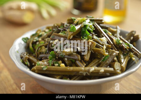 Sauteed bracken fern salad with sesame oil and seeds Stock Photo - Alamy