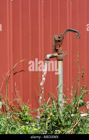 A Old water spigot with running water Stock Photo - Alamy
