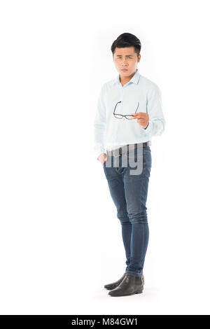 Young asian man in eyeglasses and black T-shirt leaning on table ...