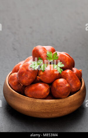 Red chorizo and black morcilla sausages hanging in a butcher shop in ...