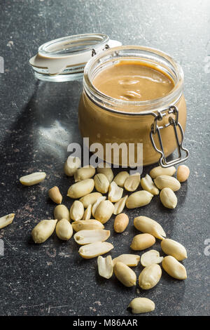 Organic Peanut Butter in Glass Jar with Peanuts in Shell on Wooden ...