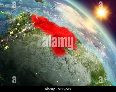 Sunrise above Venezuela highlighted in red on model of planet Earth in space with visible ...