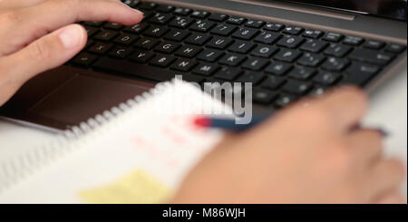 A woman's finger holding a computer keyboard Stock Photo - Alamy