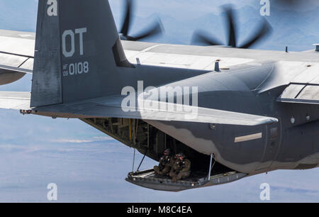 Airmen sit on the ramp of a HC-130J Combat King II cargo aircraft ...