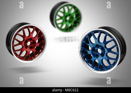 Colorful alloys rims floating in the air at white background, isolated ...