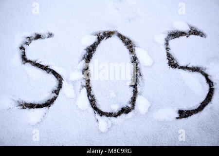 SOS sign for help needed written in the snow Stock Photo - Alamy