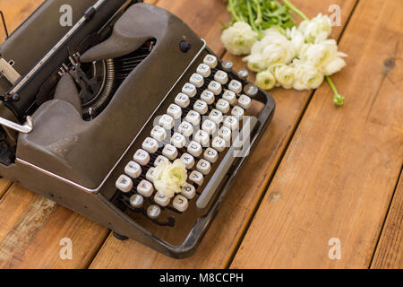 Chair with vintage typewriter and flowers in garden on spring day Stock ...