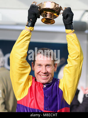Jockey Richard Johnson celebrates with the trophy after winning the ...