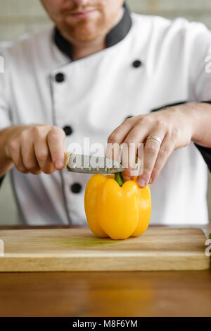 Professional chef chopping chili peppers for preparing food Stock Photo ...