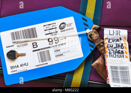 A suitcase with a airline barcode baggage tag from London Heathrow (LHR ...