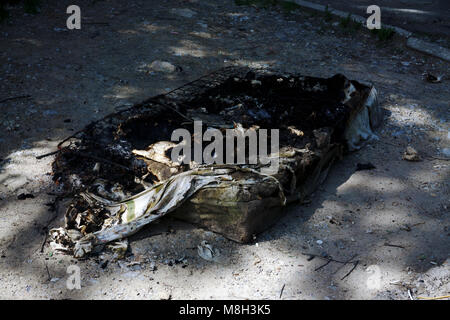 a burned mattress lies on the pavement after a fire Stock Photo - Alamy