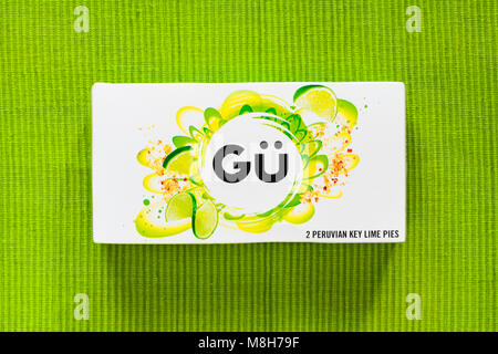 Gü box of Gu 2 Peruvian key lime pies set on lime green textured ...