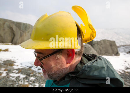 A man wearing a shattered hard hat Stock Photo - Alamy