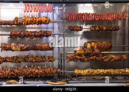 Greek Gyros spit on a grill. A man cutting meat off Stock Photo - Alamy