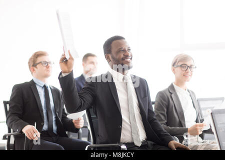 African american manager asking employee to show him company project ...