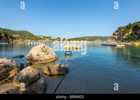 Alipa beach in Paleokastritsa bay with sand and crystal sea water ...