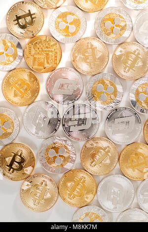 several aligned crypto currency coins on a white background Stock Photo ...