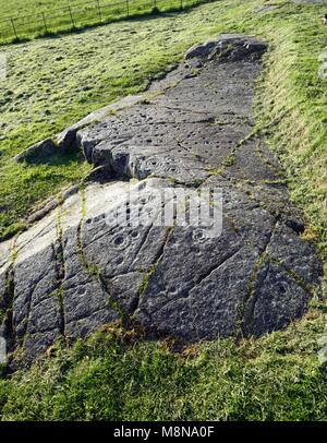 Cup and ring mark marks prehistoric Neolithic rock art on natural rock ...