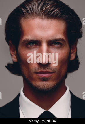 closeup face of responsible business men on a grey background Stock ...